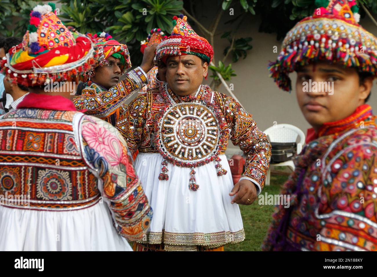 Indians wearing traditional attire get ready to practice Garba, the ...