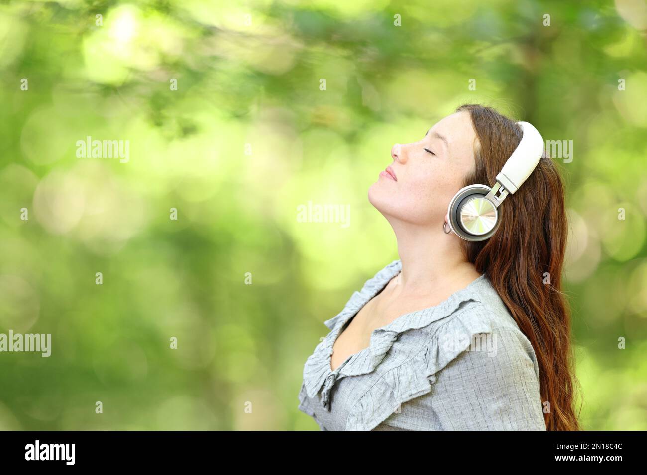 Profile of a woman meditating listening audio guide Stock Photo - Alamy