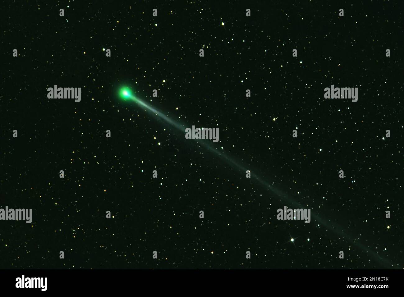 Green comet in dark space. Elements of this image furnished by NASA ...