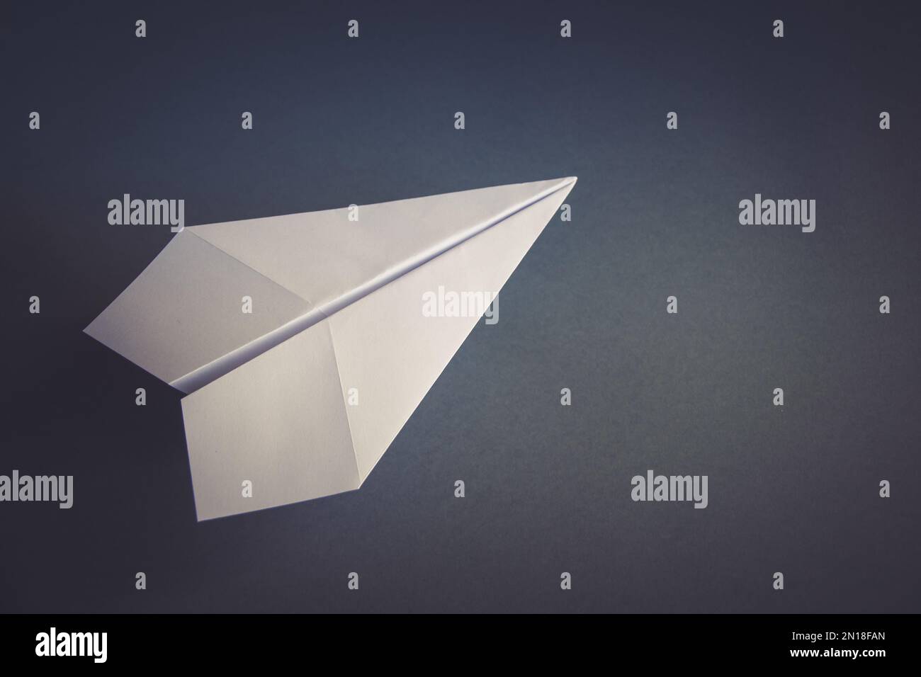 White paper plane origami isolated on a blank grey background Stock ...