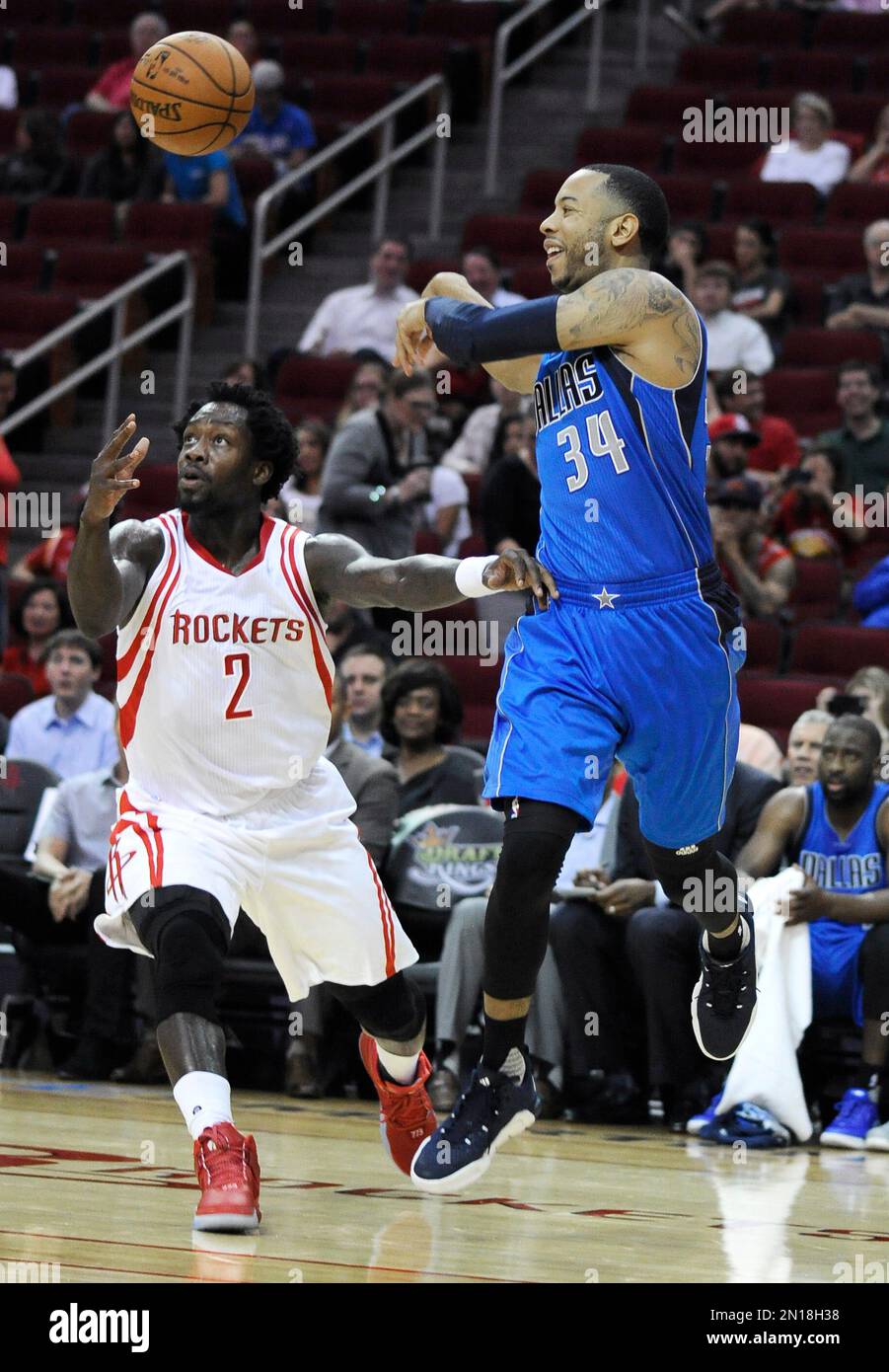Dallas Mavericks' Devin Harris (34) passes the ball over Houston ...