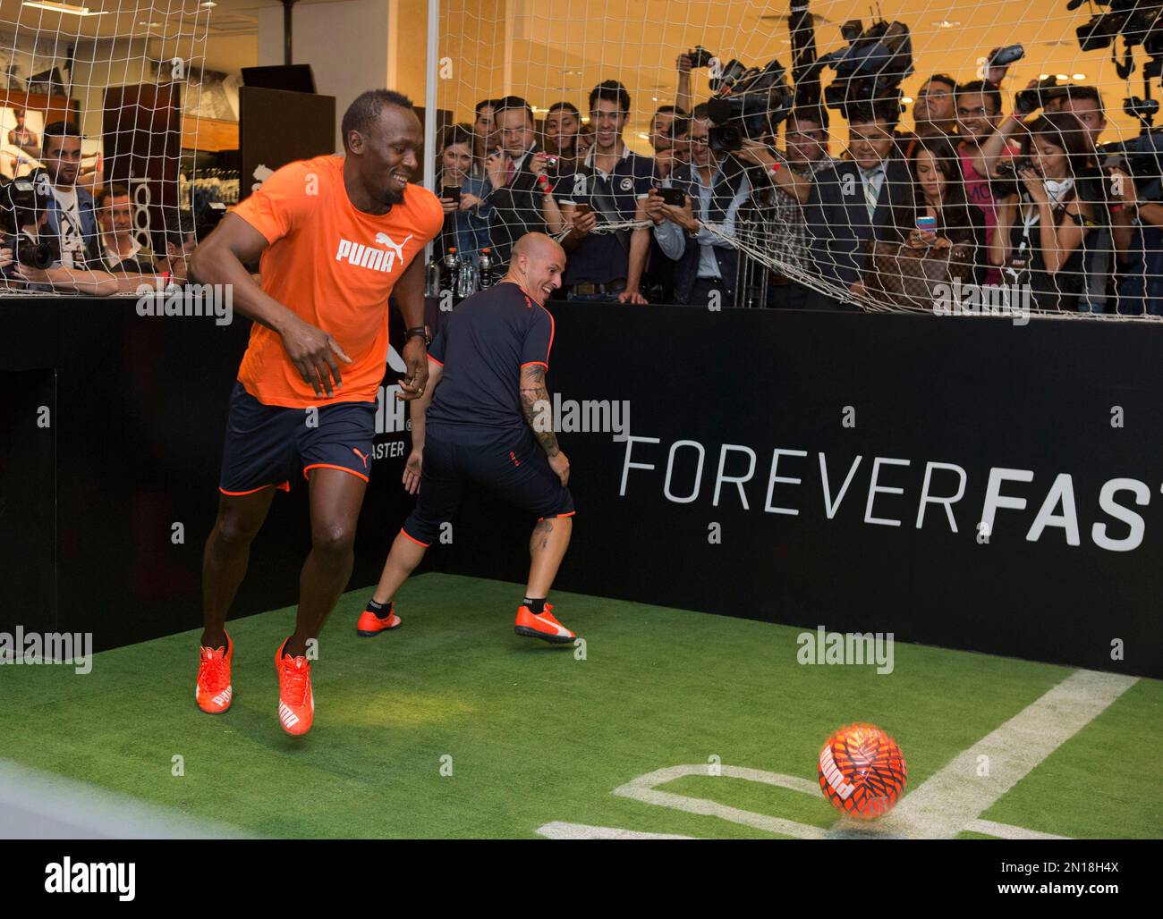 Jamaican sprinter Usain Bolt, left, plays a mini soccer match against ...