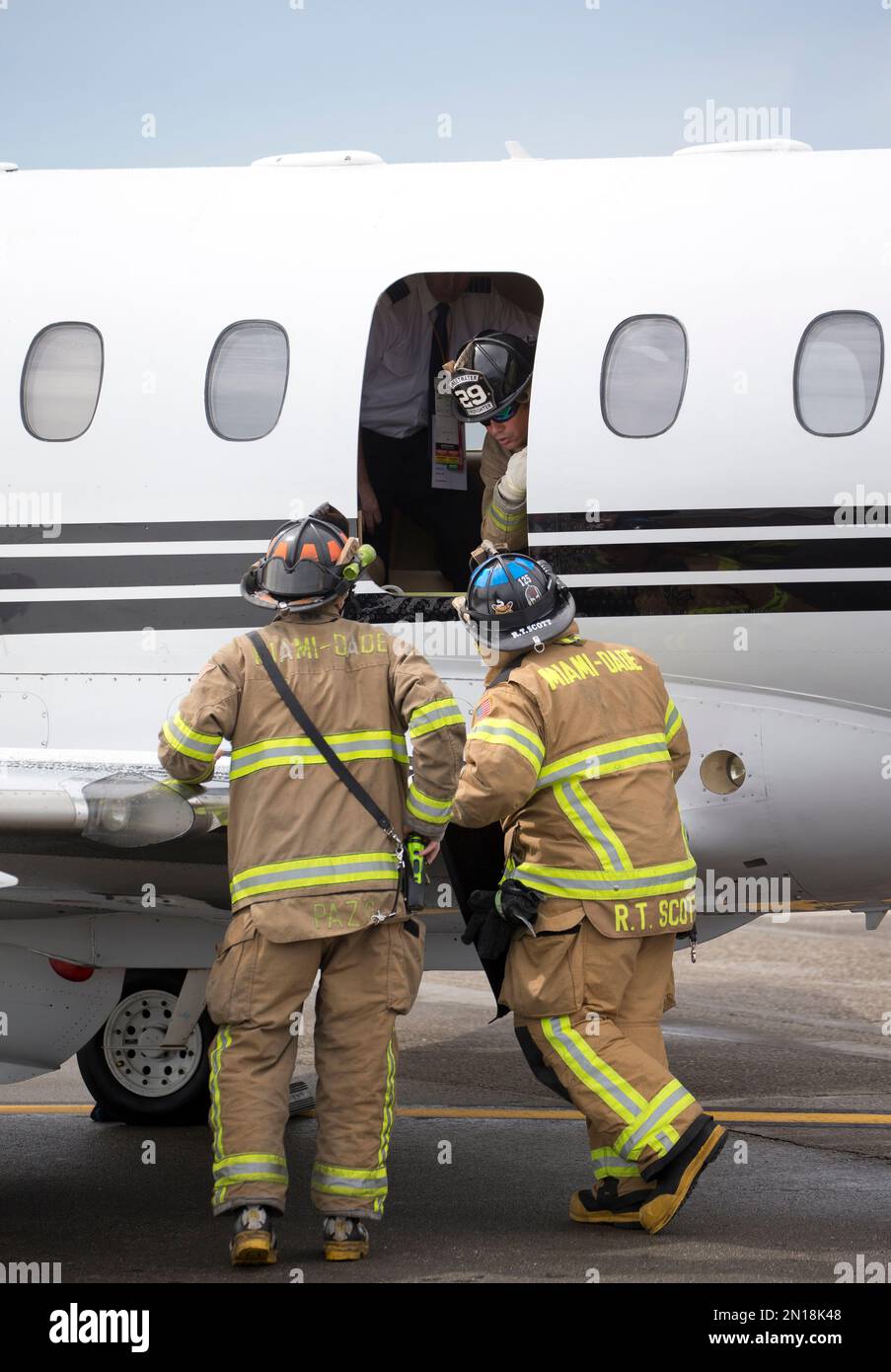 Miami-Dade Fire Rescue firefighters inspect a Raytheon Aircraft Company ...