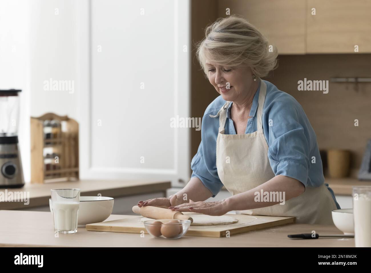 Positive focused mature female baker preparing dessert, pastry Stock ...