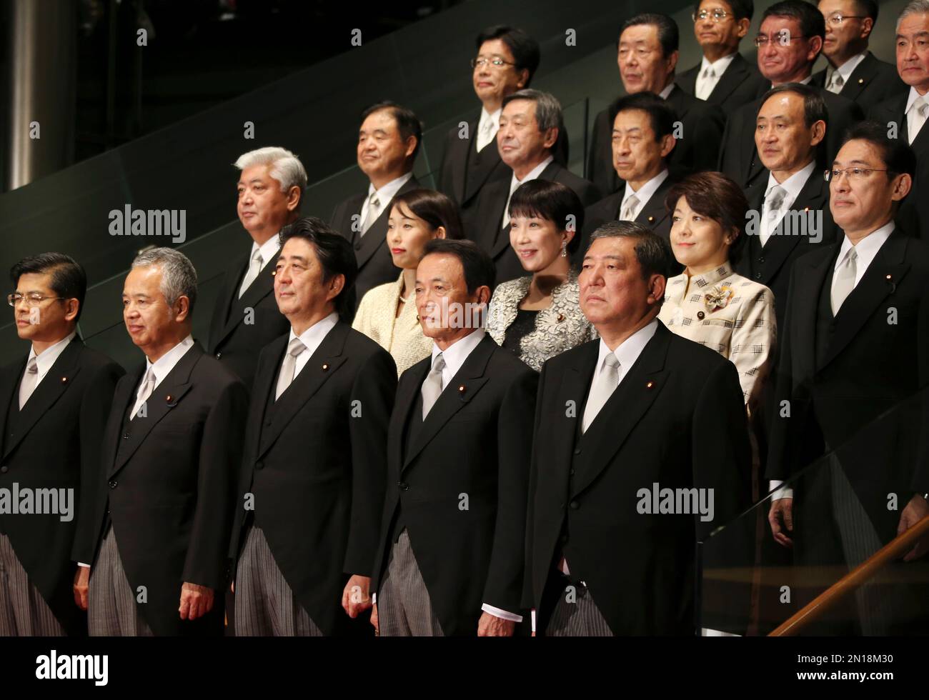 Japanese Prime Minister Shinzo Abe, center at bottom row, and his new ...