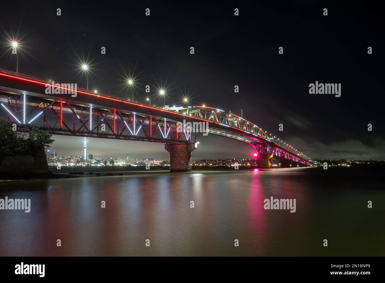 Auckland Harbour Bridge glowing in red. Auckland, New Zealand Stock ...