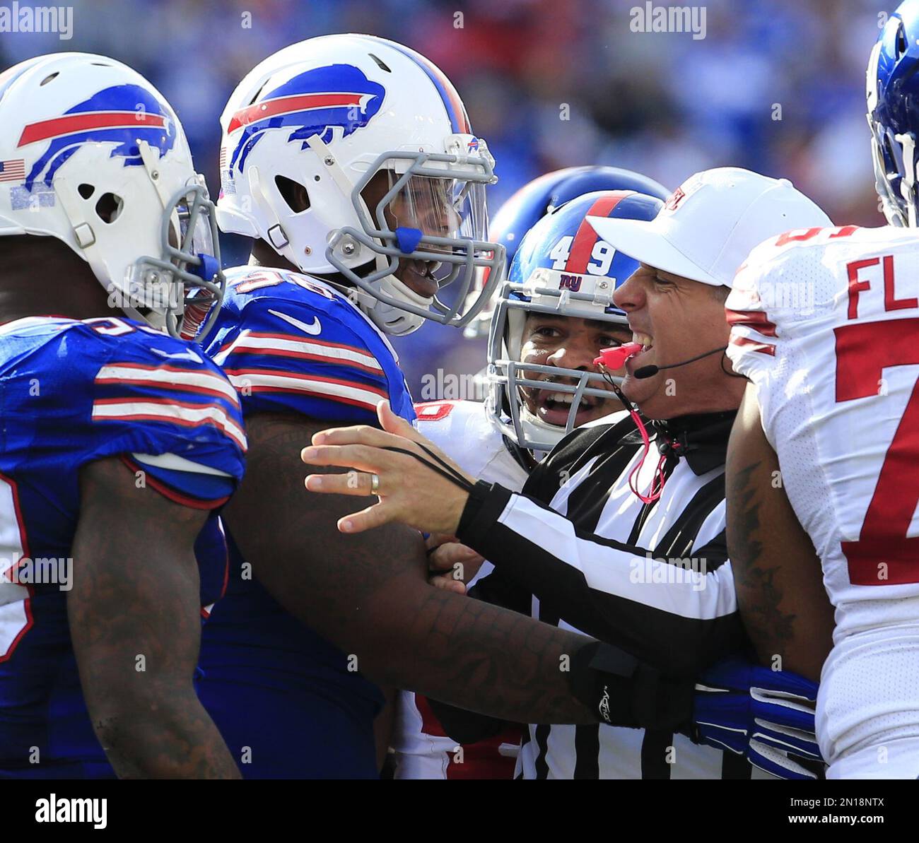 NFL referee John Hussey restrains Buffalo Bills defensive tackle Stefan ...