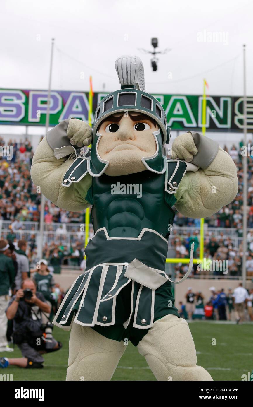 Michigan State mascot Sparty flexes his muscles before an NCAA college ...