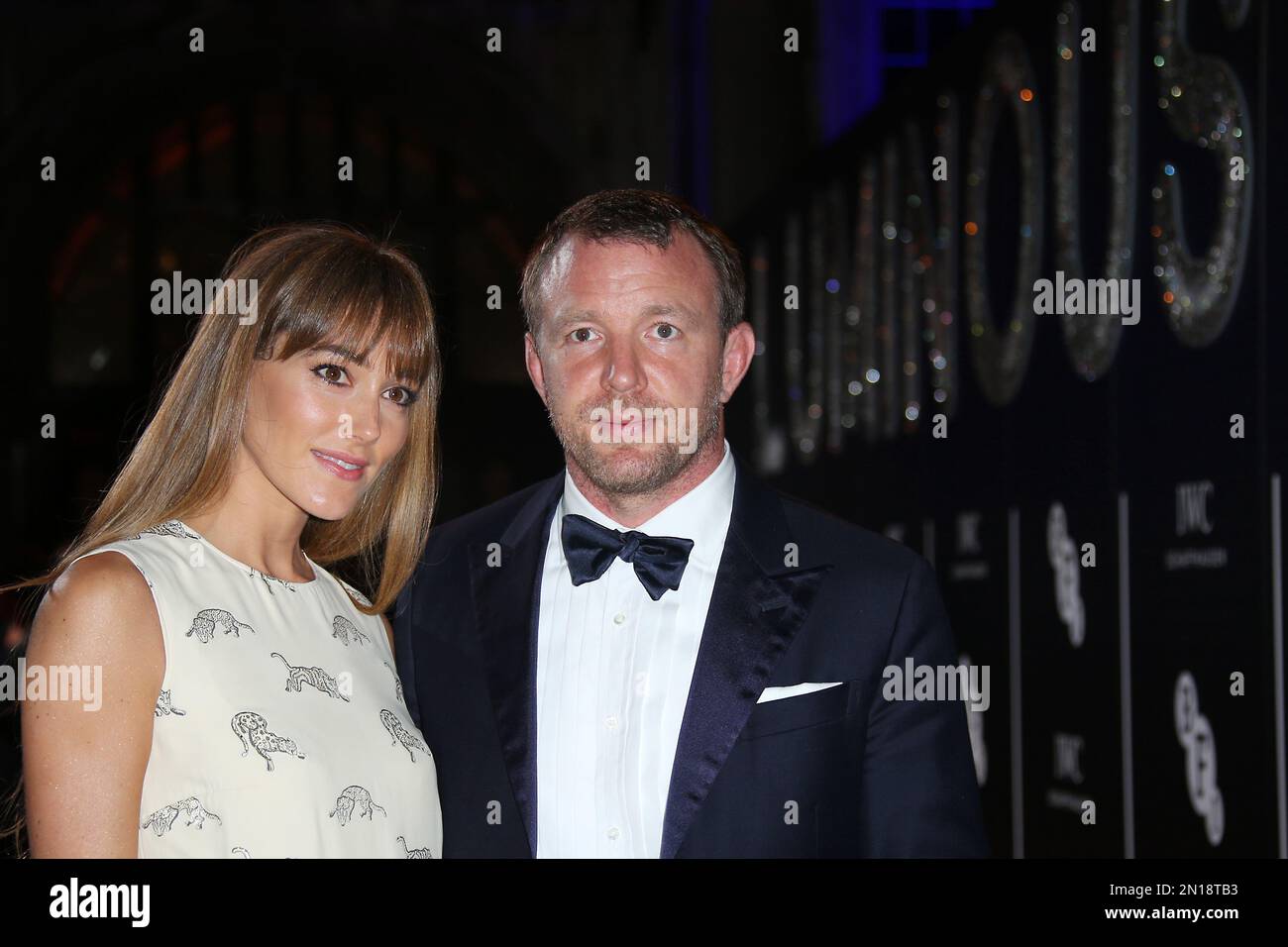 Guy Ritchie, right, and his wife Jacqui Ainsley pose for photographers ...