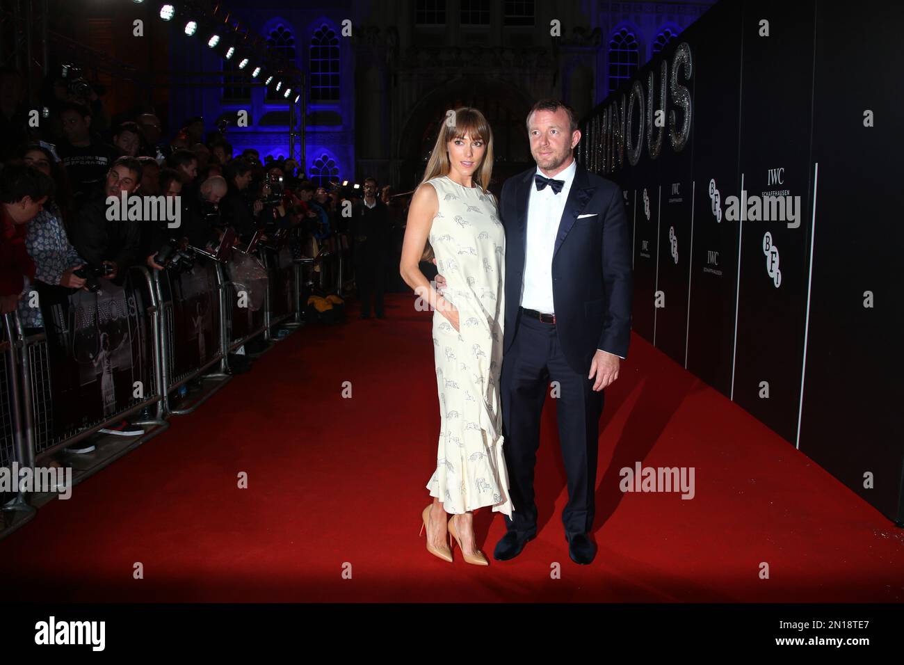 Guy Ritchie, right, and his wife Jacqui Ainsley pose for photographers ...