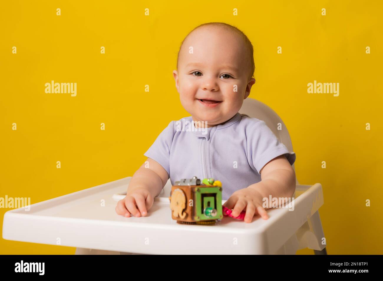 a cute kid is sitting in a child's chair playing with an educational ...