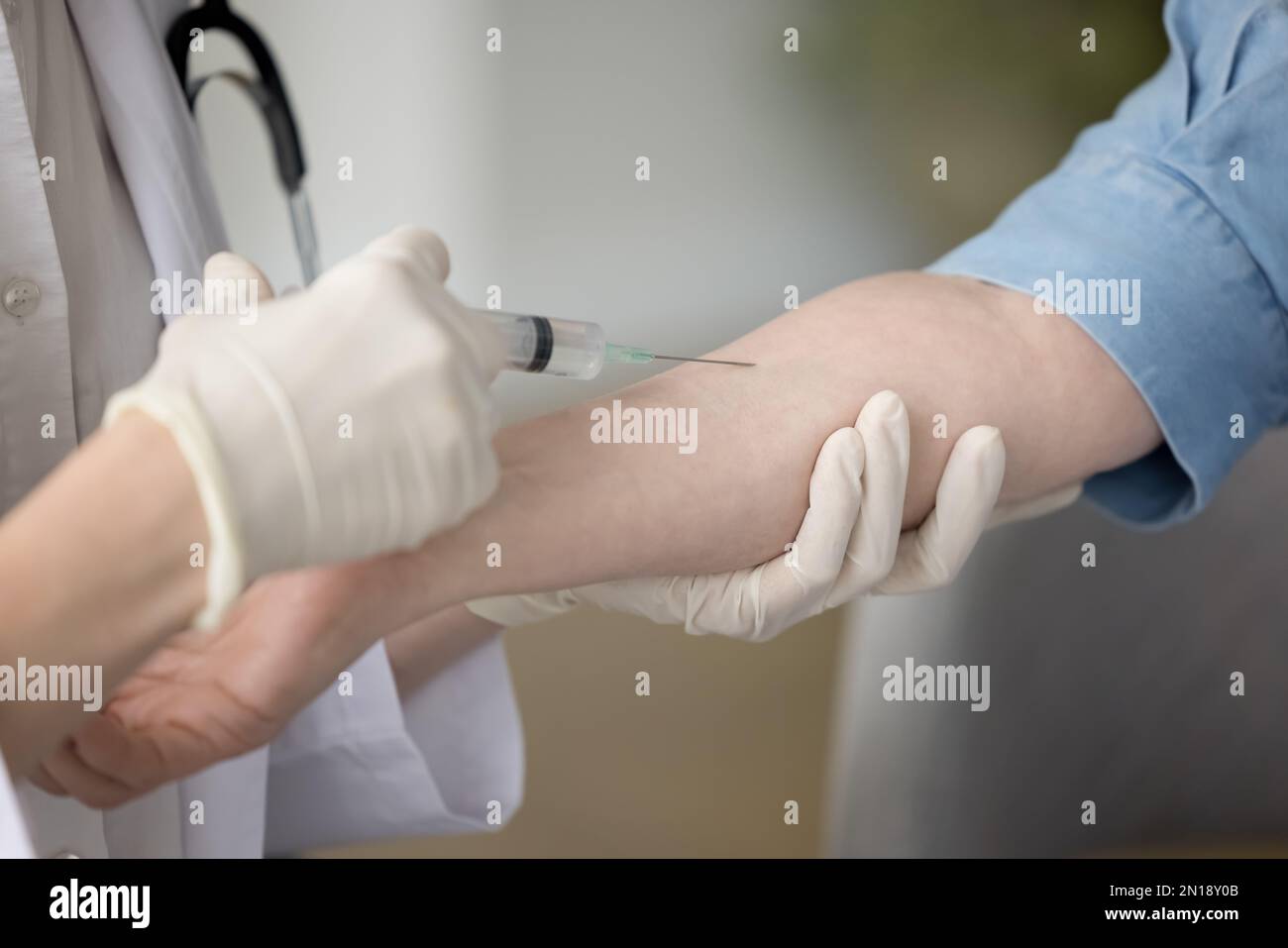 Physician doctor giving shot to adult older patient against flu Stock ...