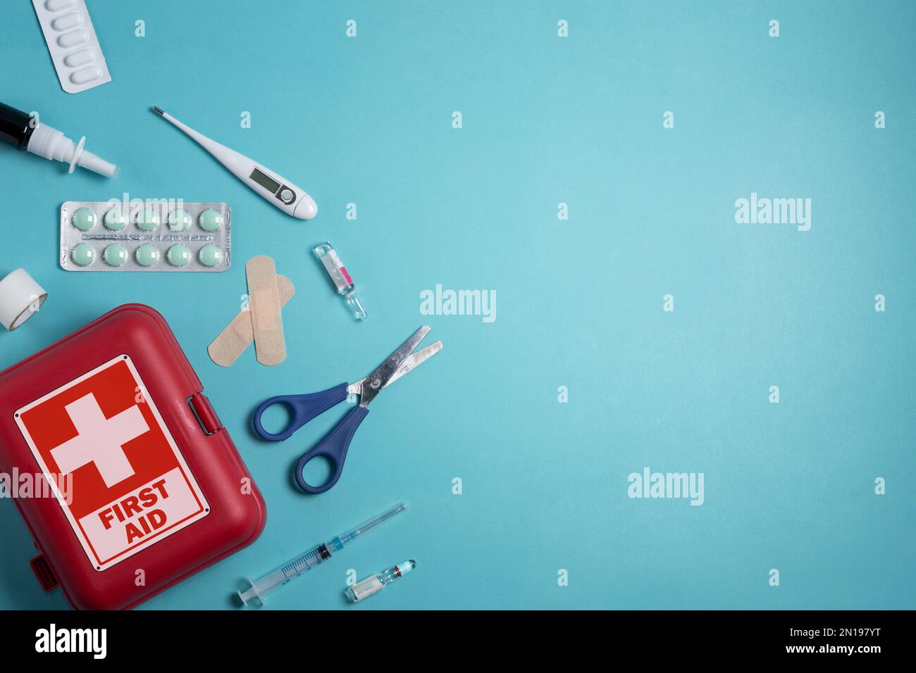 Home first aid kit on a blue background. The elements of the first aid ...