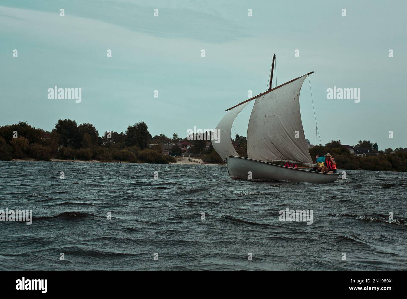 Sailboat floating on water gloomy landscape photo Stock Photo - Alamy