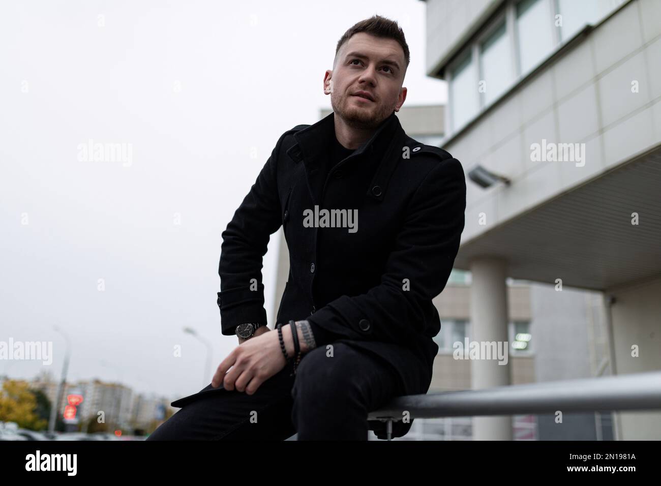 stylish brutal man defiant looking at camera outside Stock Photo - Alamy