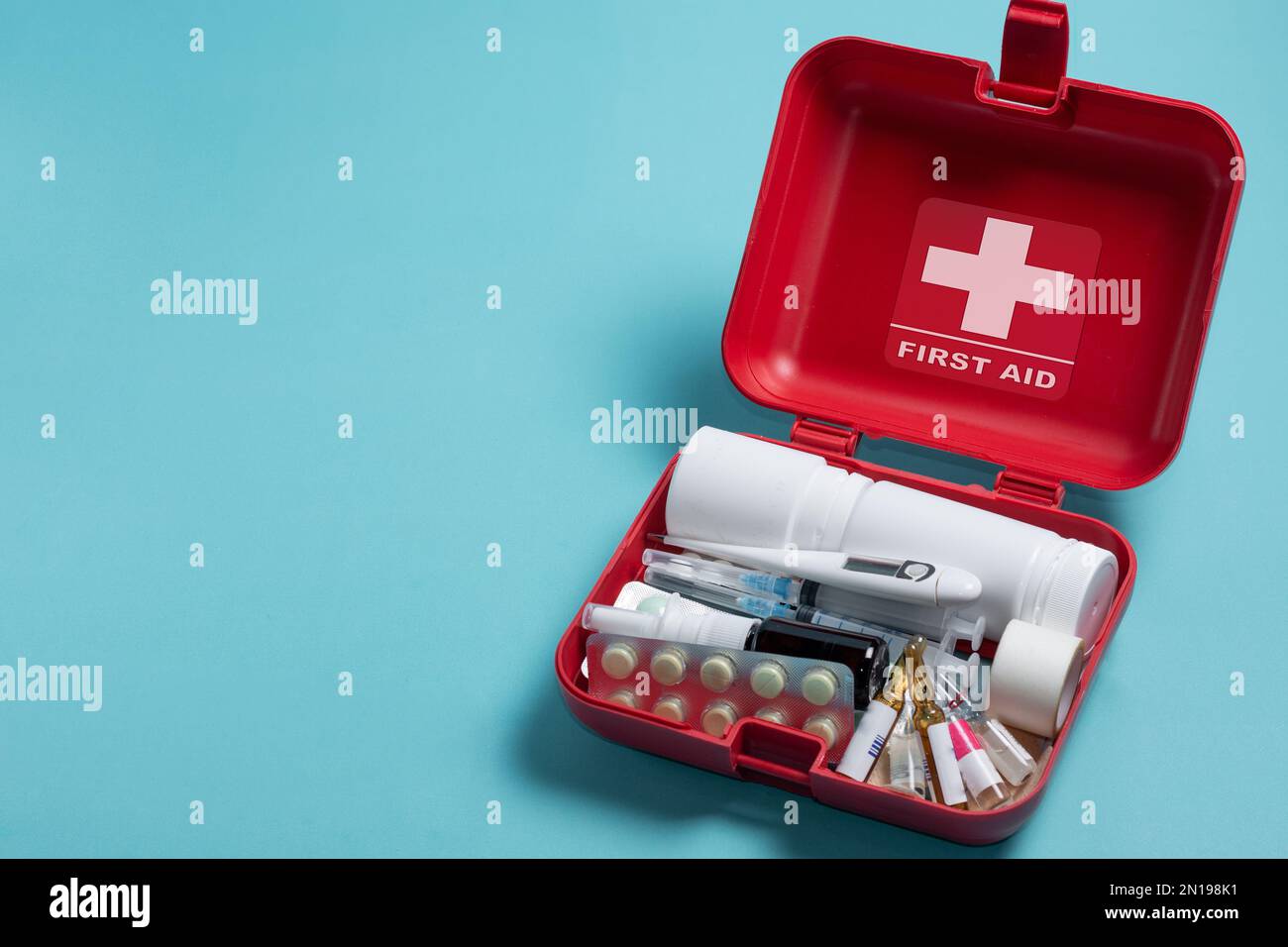 Home first aid kit on a blue background. The elements of the first aid ...