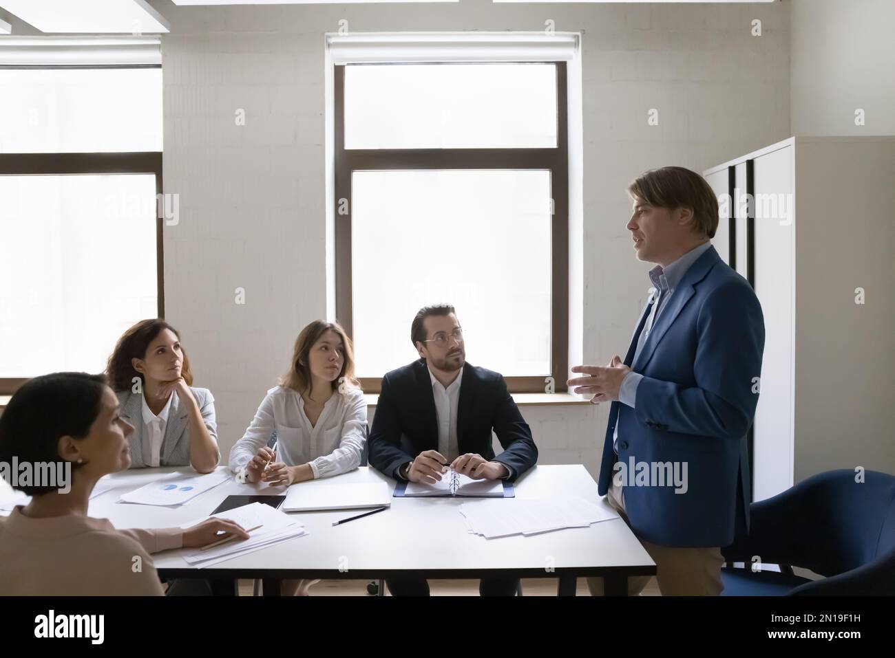 Serious middle aged boss talking to employees on briefing Stock Photo ...