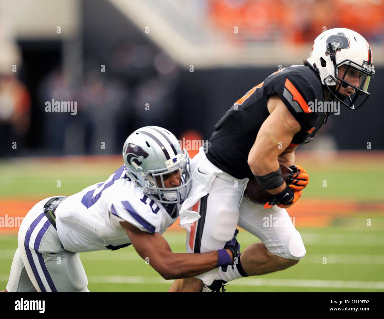 Kansas State defensive back Donnie Starks, left, tackles Oklahoma State ...