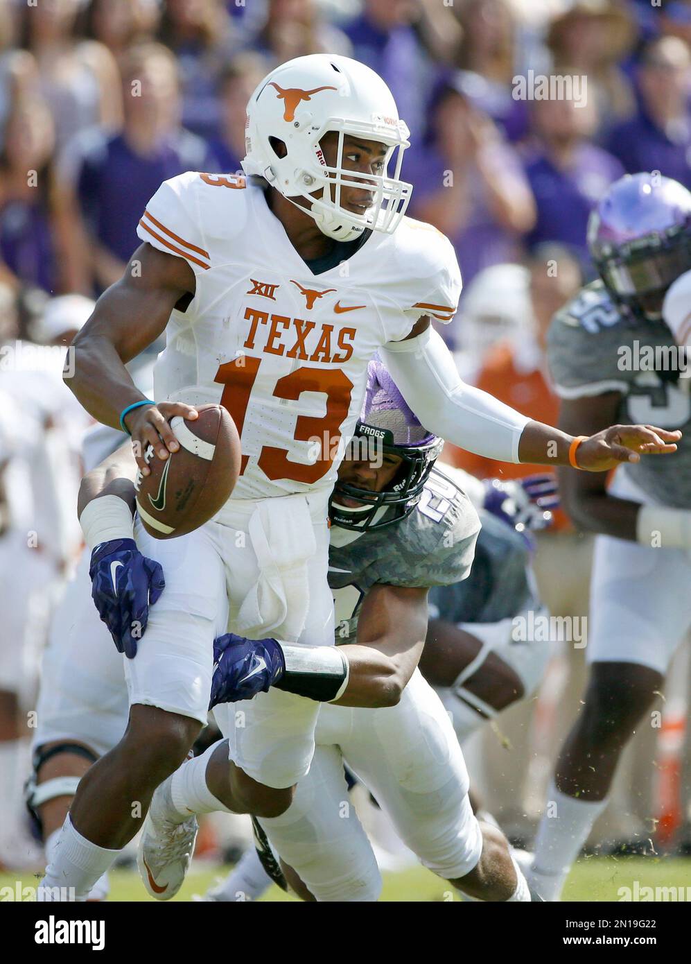 Texas quarterback Jerrod Heard (13) is hit by TCU linebacker Montrel Wilson (20) in the first ...