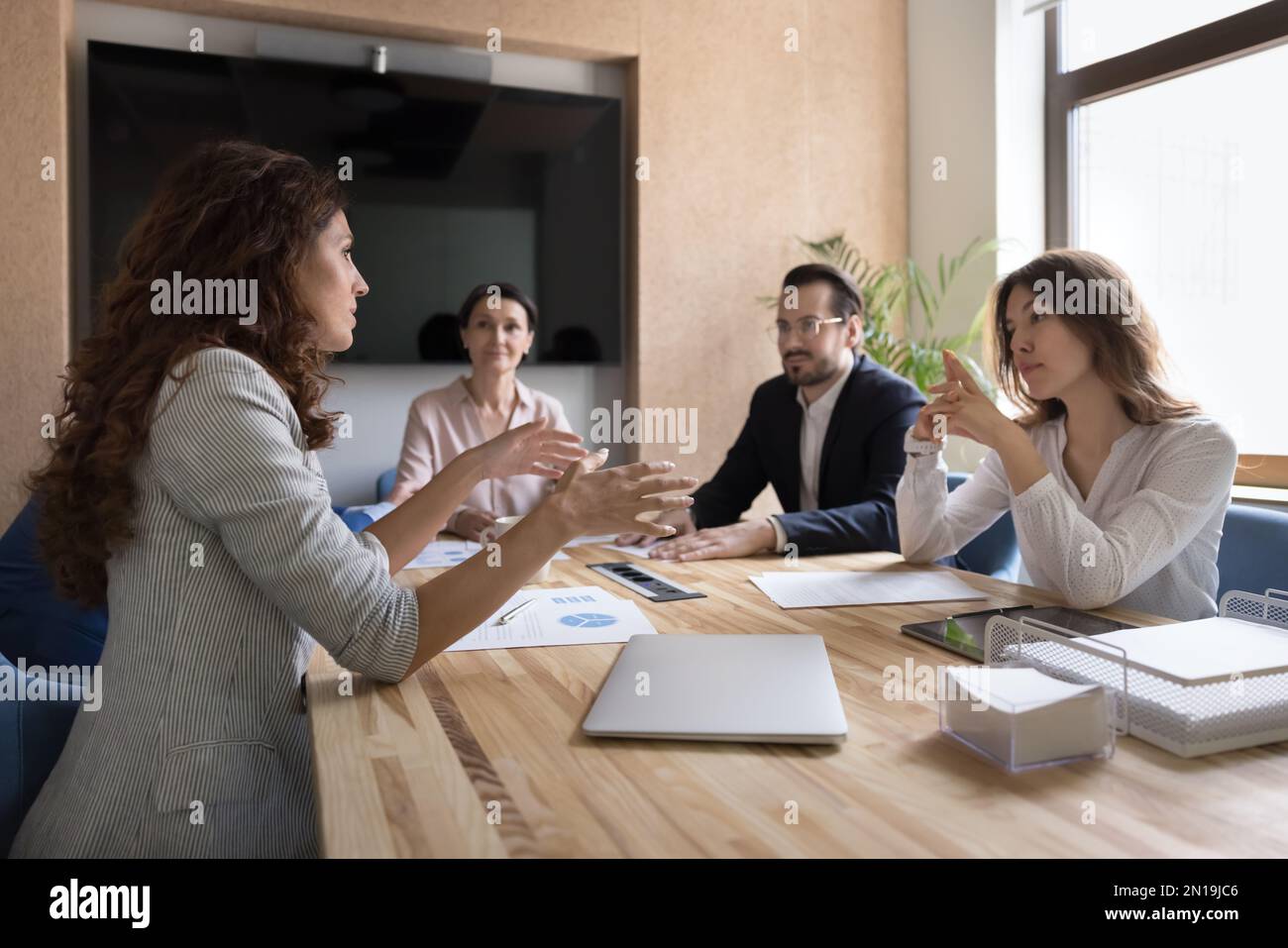 Serious female business partners talking at meeting table Stock Photo ...