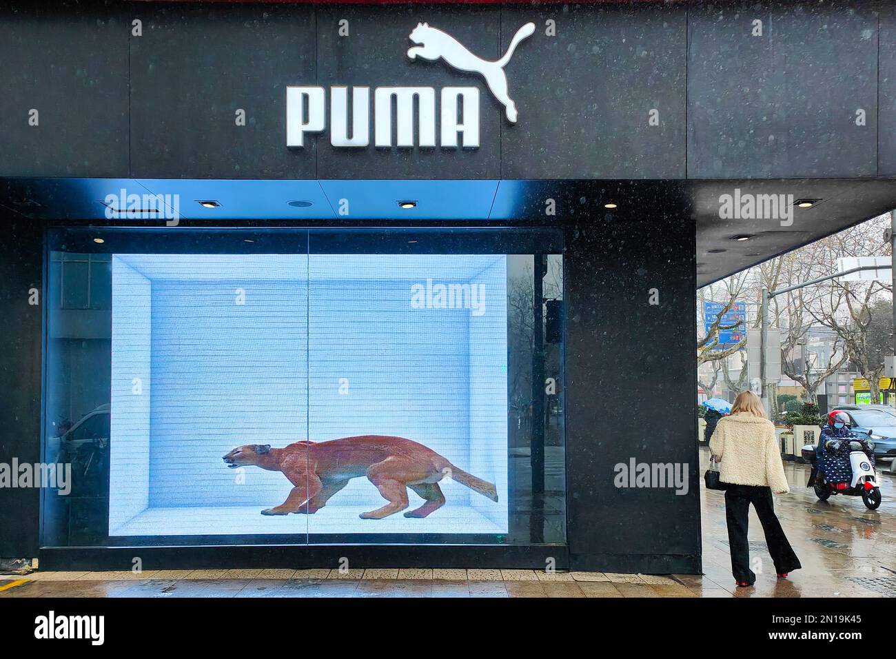 SHANGHAI, CHINA - FEBRUARY 6, 2023 - Citizens walk past PUMA clothing ...