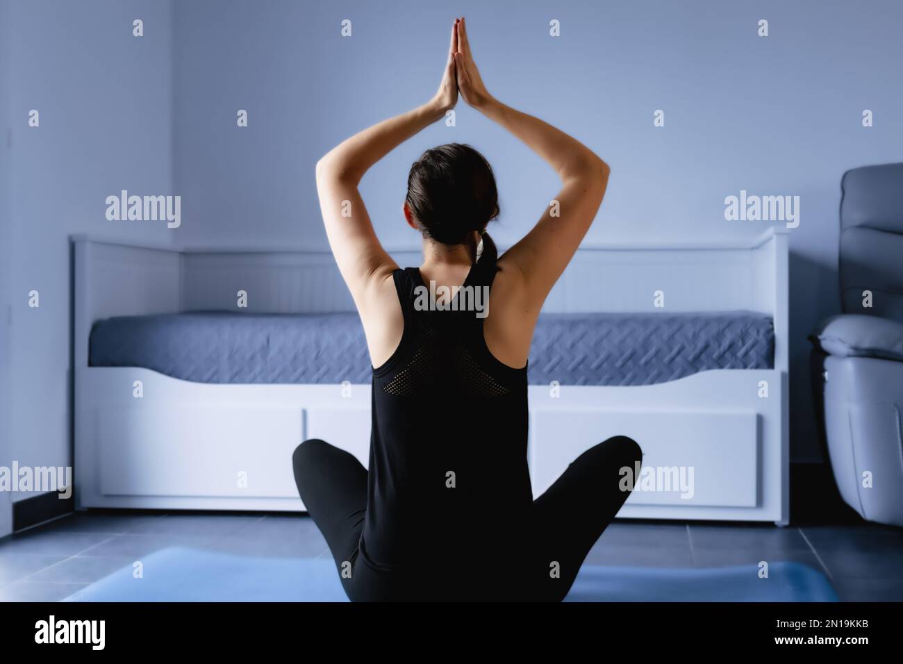Woman practicing yoga indoor for training, stretching and relaxation ...