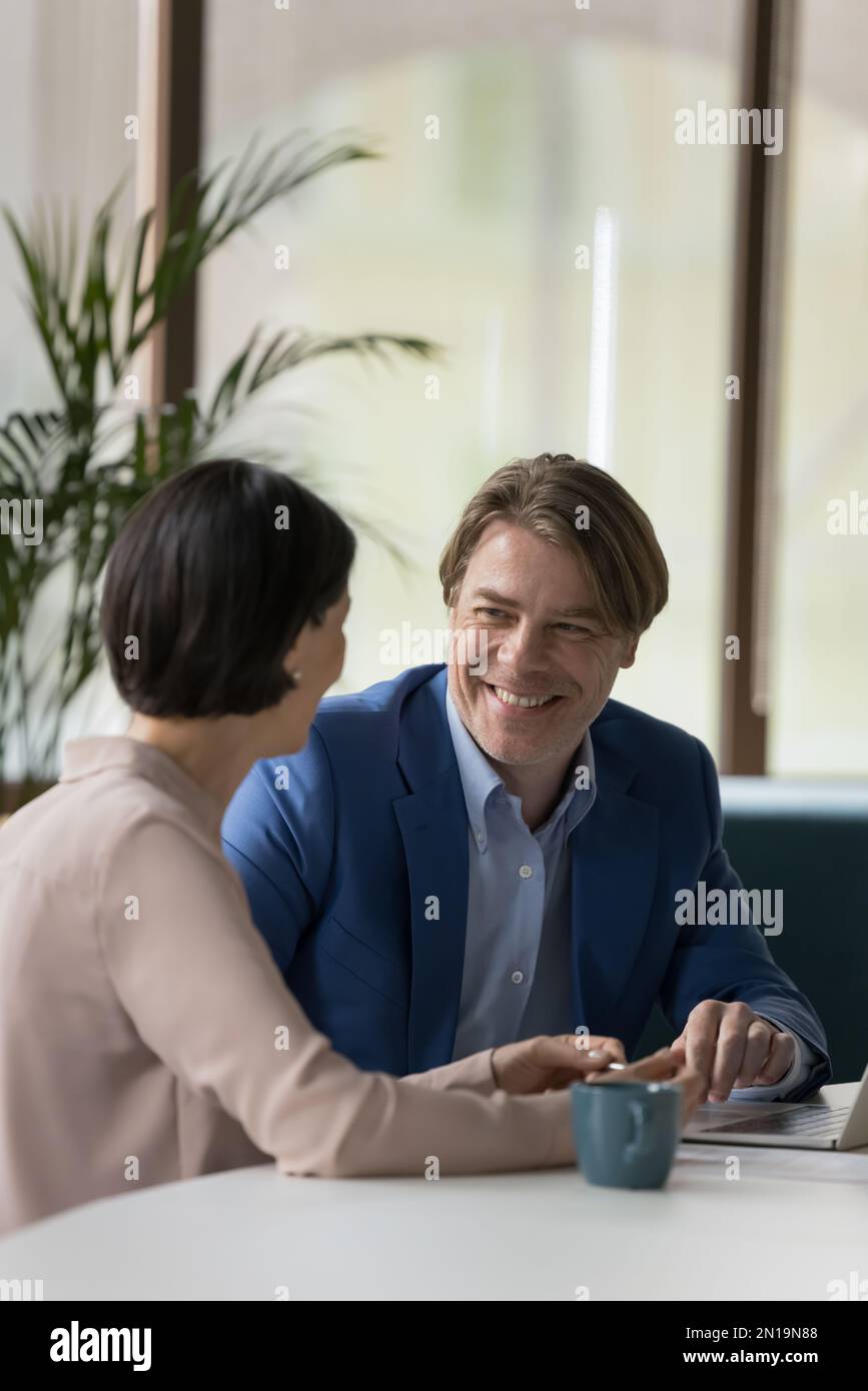 Two happy office colleagues enjoying cooperation, teamwork job success ...