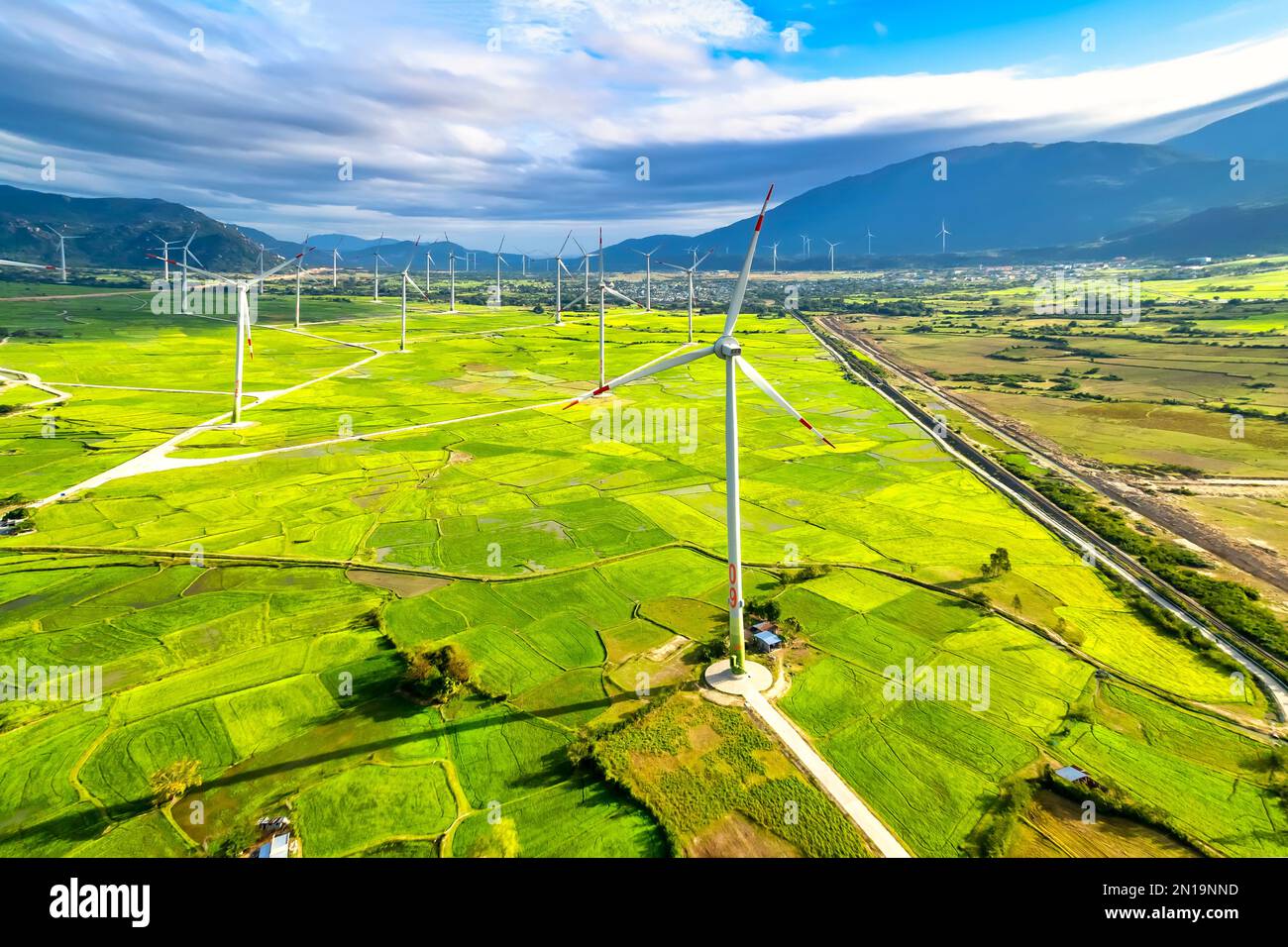 Panoramic view of wind farm or wind park. Green meadow with Wind ...