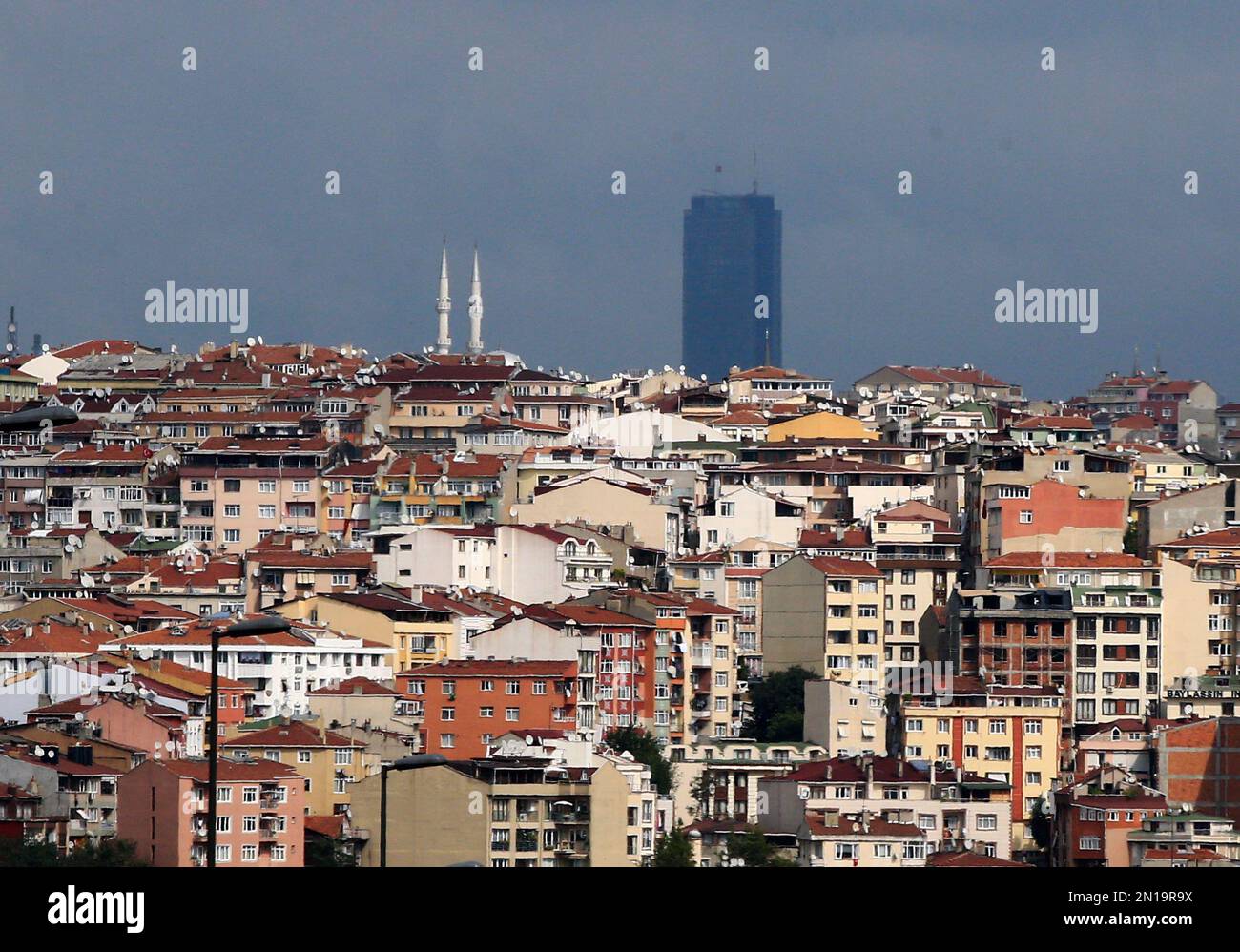 A mosque's minarets and a high-rise building dominate the skyline in ...