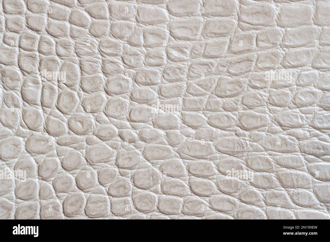 Texture of genuine leather close-up, embossed under light color print ...