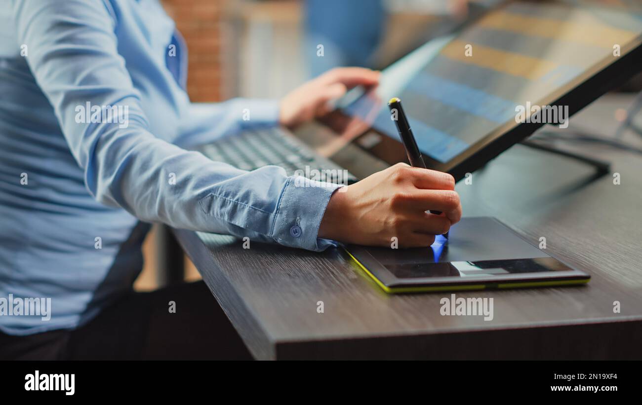 Female photographer working as retoucher with tablet and stylus pen ...