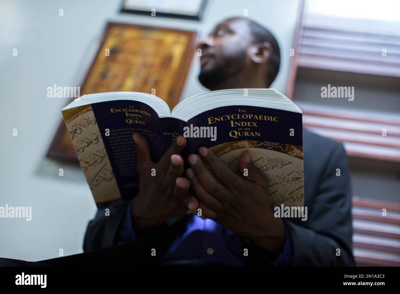 Rashad Abdul-Rahman holds a book at the Atlanta Masjid of Al Islam ...