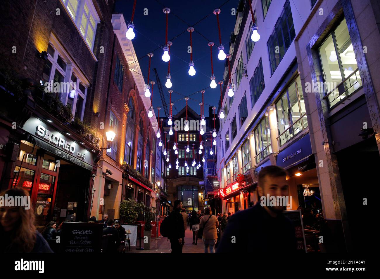 People walk along Ganton Street, London, Wednesday, Sept. 30, 2015 ...