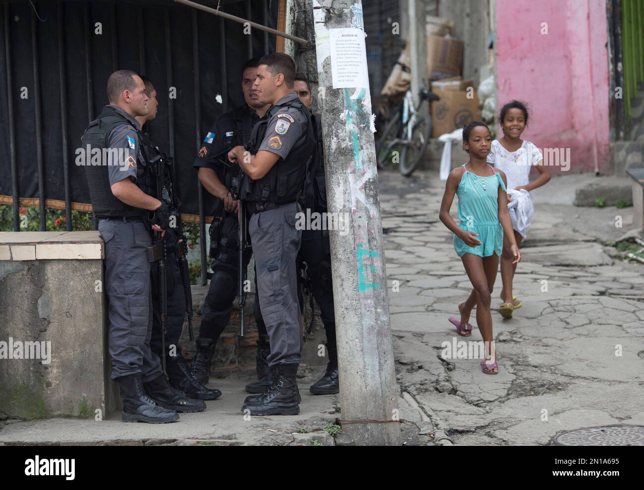 Police officers stand guard at the entrance of Morro da Providencia ...
