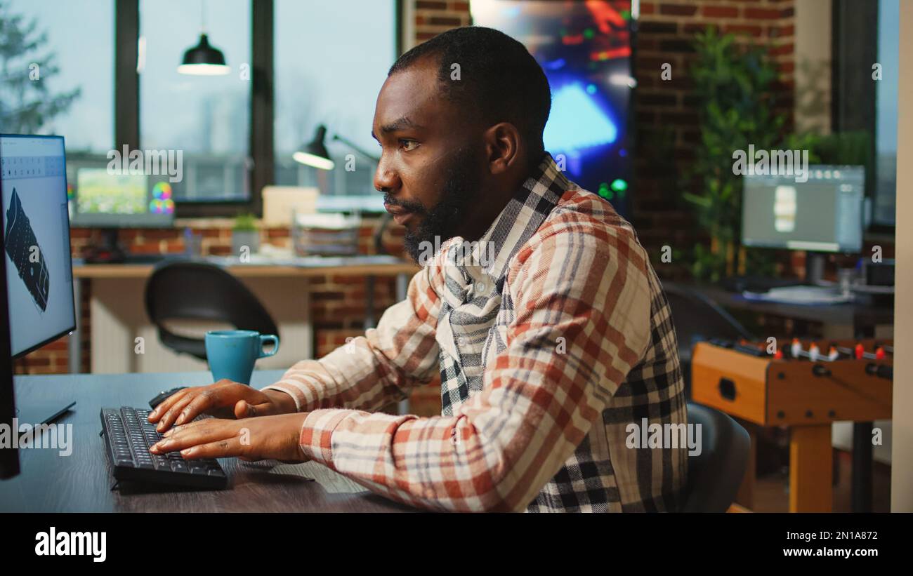 African american man working on 3d engineering or cgi using cad ...