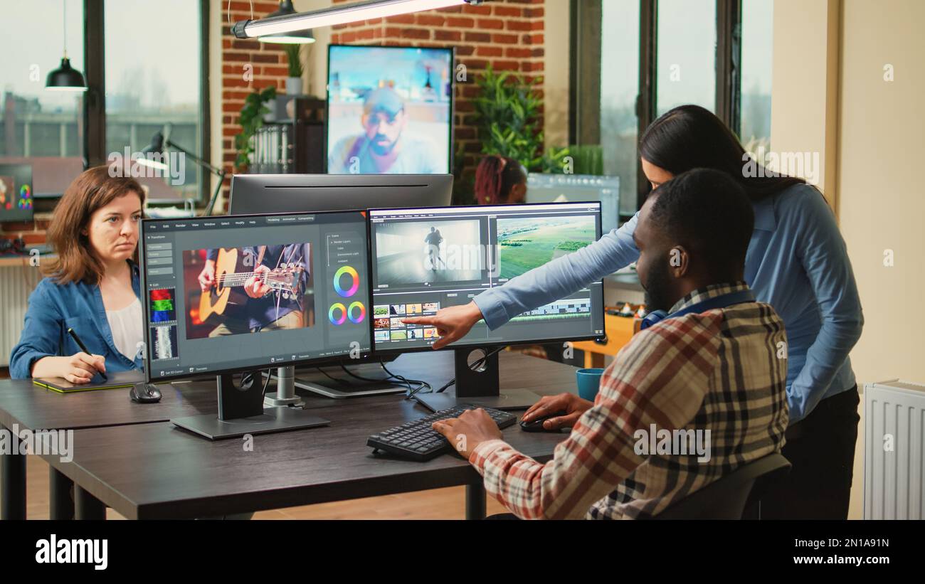 Diverse videographers editing creative film montage on software ...