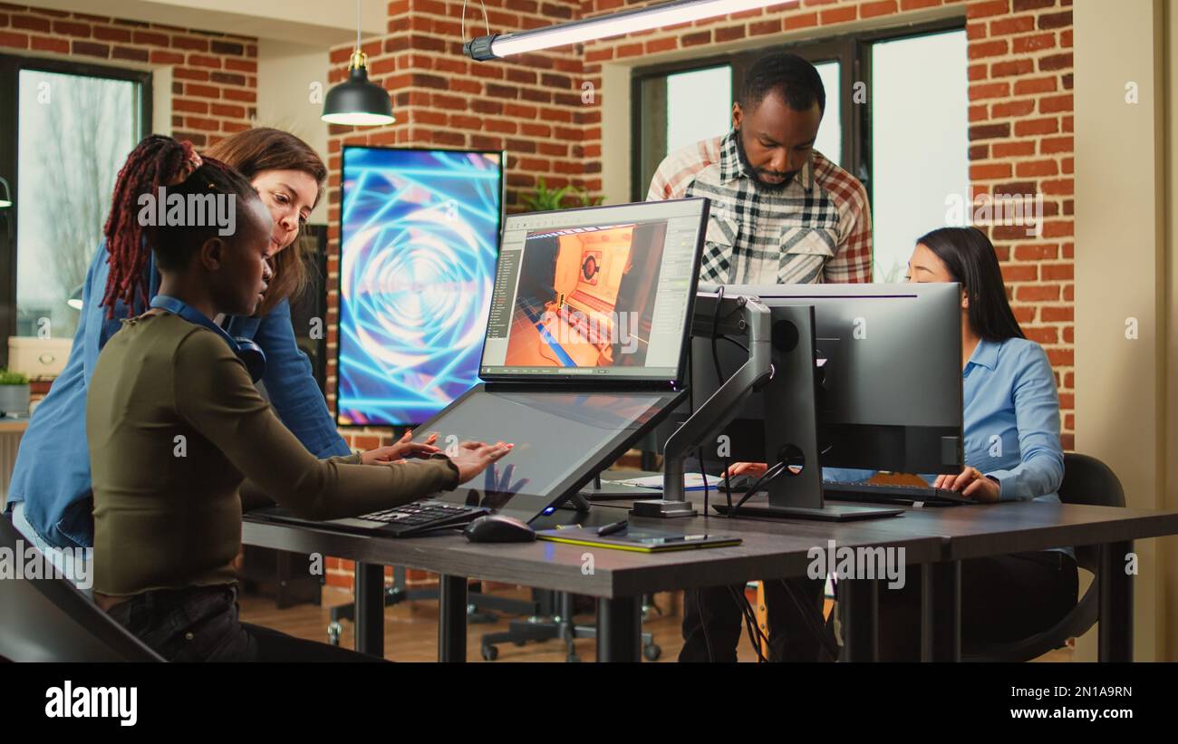 Multiethnic coworkers analyzing graphic developing technology and new ...