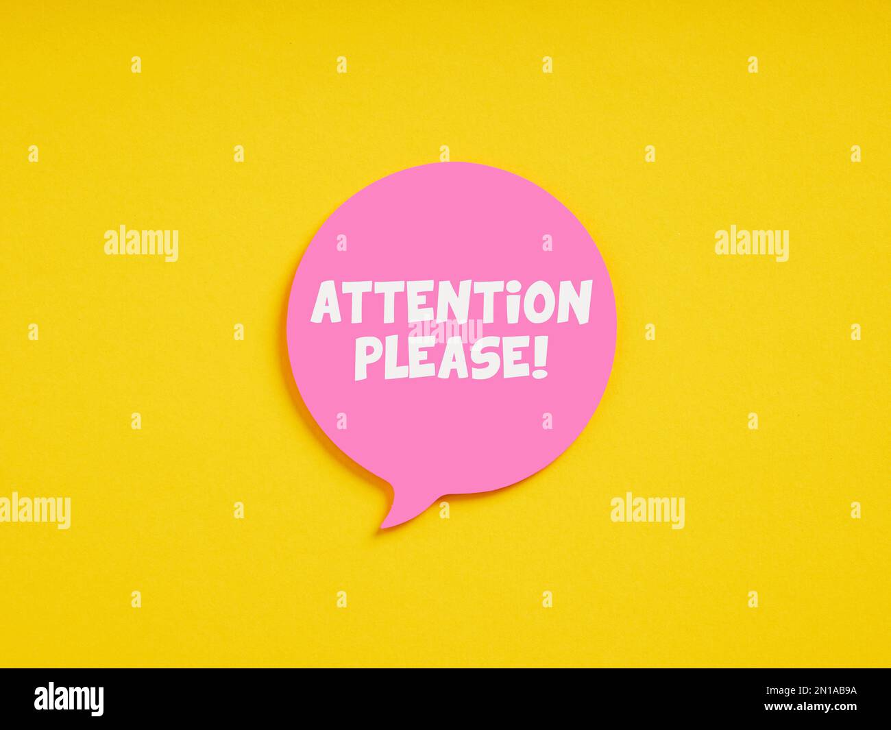 The message attention please on pink speech bubble on yellow background ...
