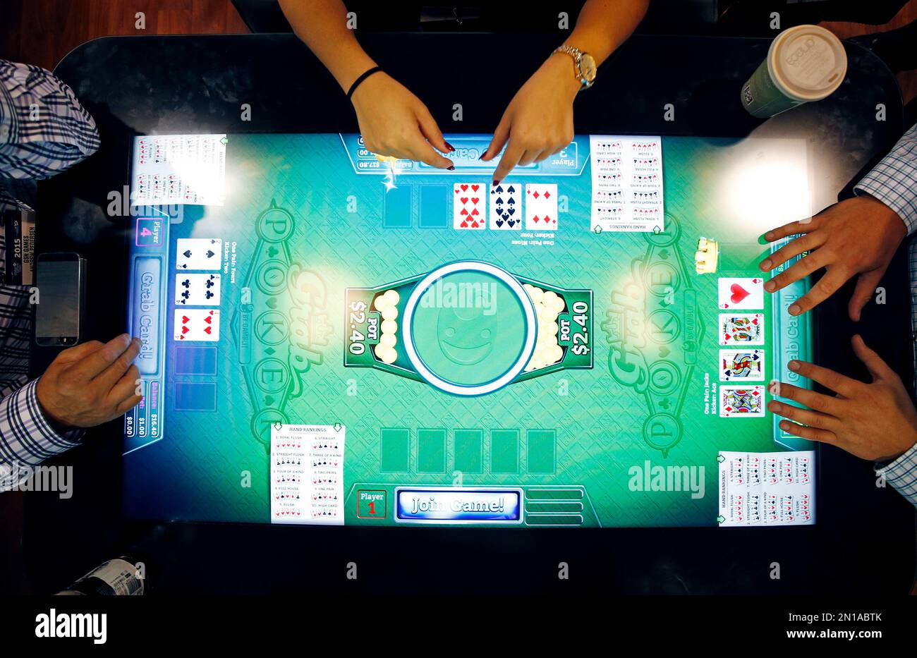 People try out Grab Poker, a skill-based gaming machine, at the Gamblit ...