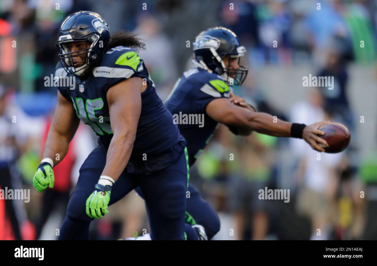 Seattle Seahawks fullback Will Tukuafu, left, blocks for quarterback ...