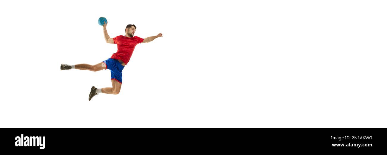 Young man, professional athlete playing handball isolated over white ...