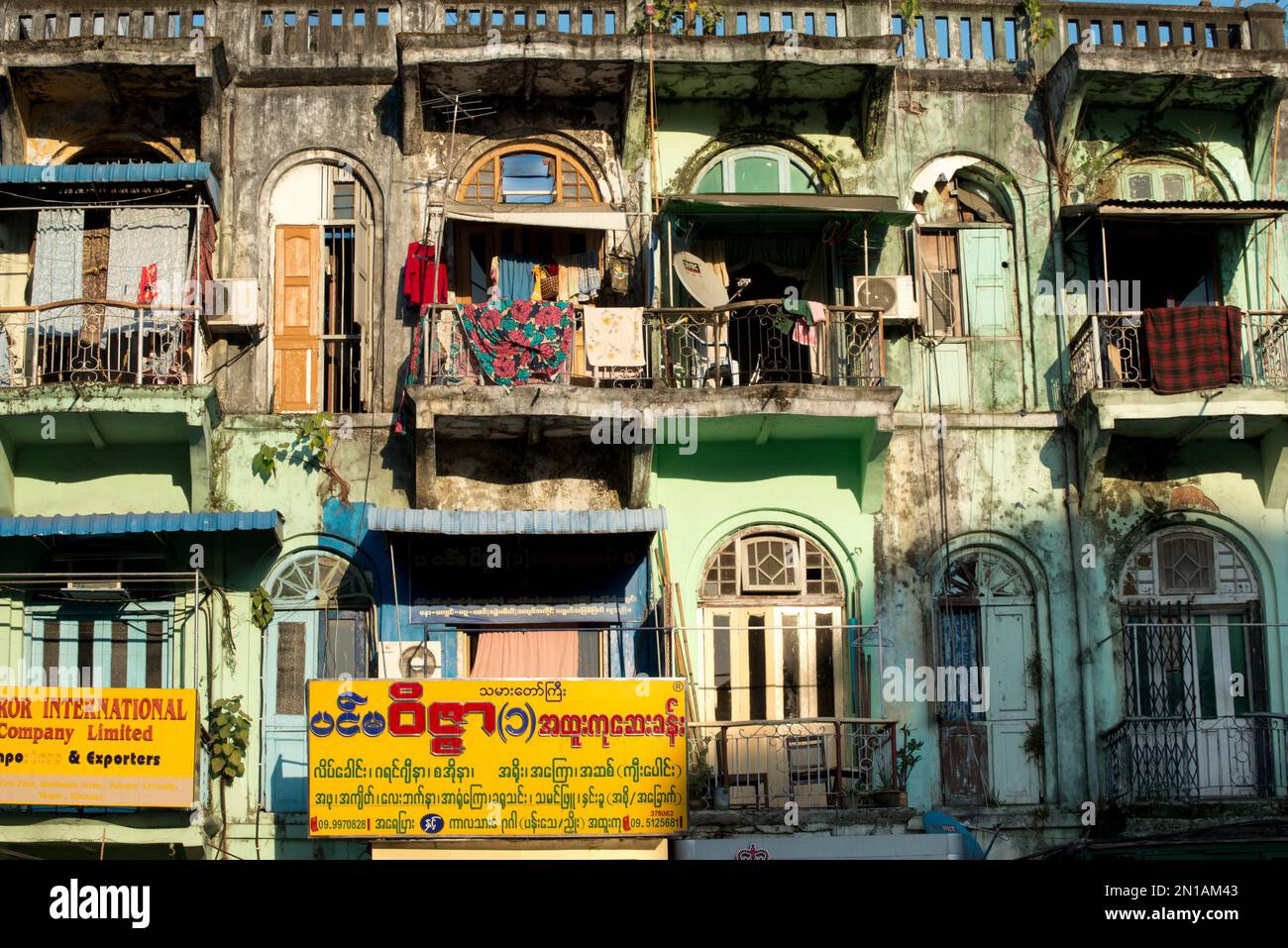 Old building terraces with Myanmarese script signs, Yangon, Myanmar ...