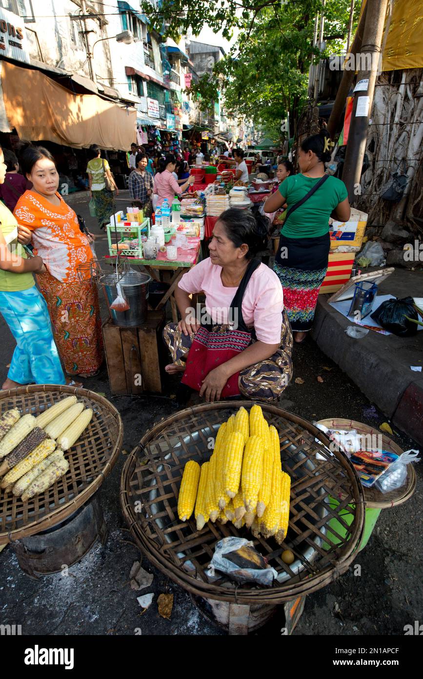 Woman selling corn on road, Yangon, Myanmar Stock Photo - Alamy