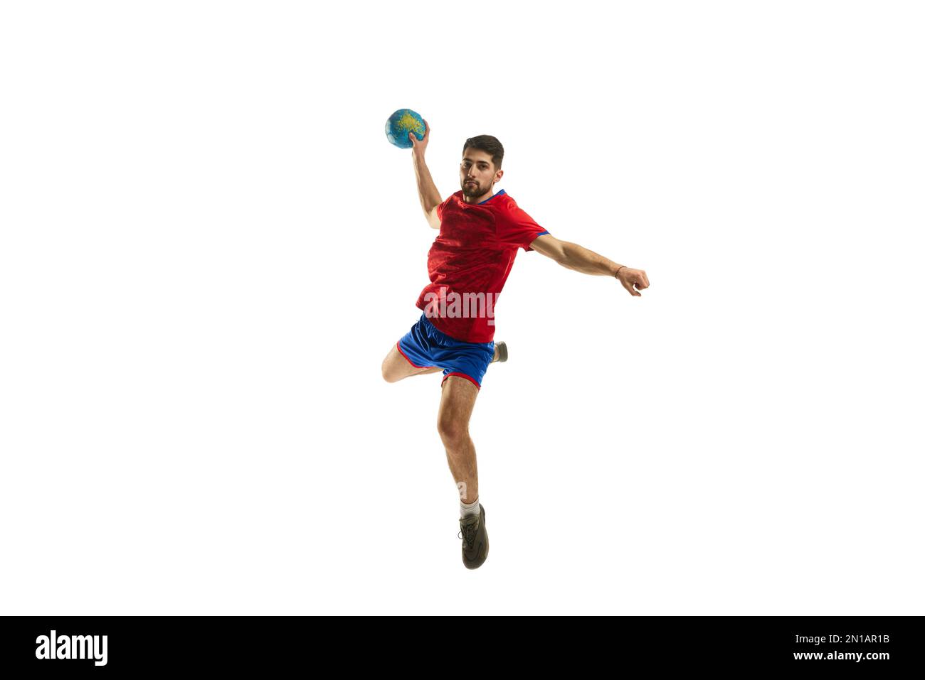 Strength. Dynamic studio shot of professional male handball player in ...