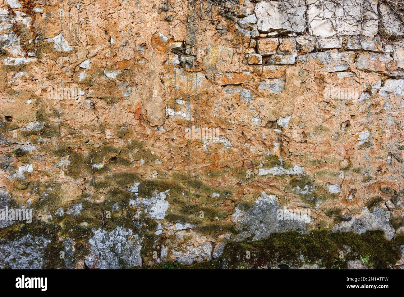 Old ruined stone wall with moss as grunge background Stock Photo - Alamy
