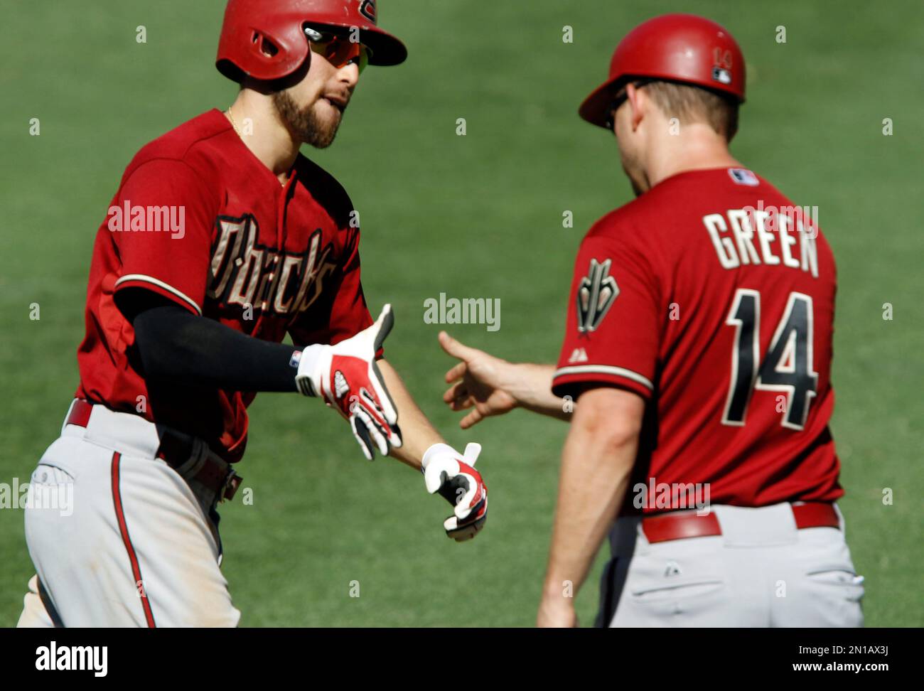 Arizona Diamondbacks third base coach Andy Green (14) congratulates ...