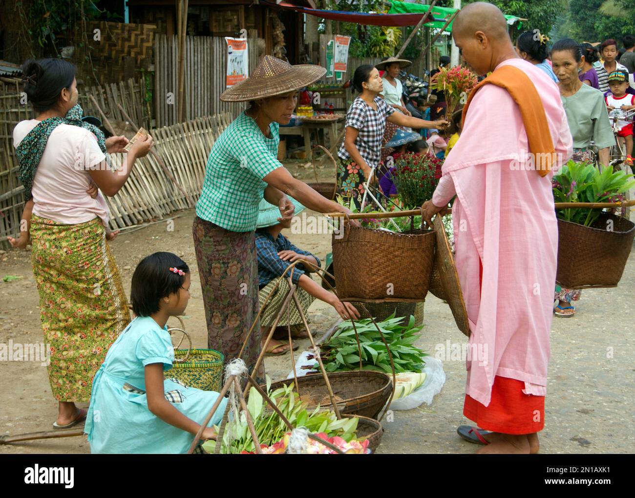 In this Sunday, Sept 27, 2015 photo, a flower vendor donates cash to a ...