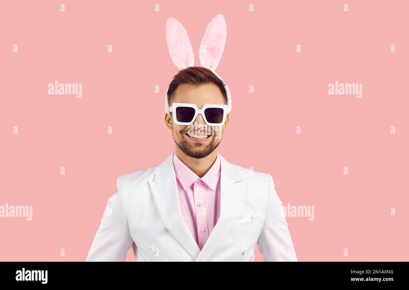 Studio portrait of happy smiling handsome young man in suit and easter ...