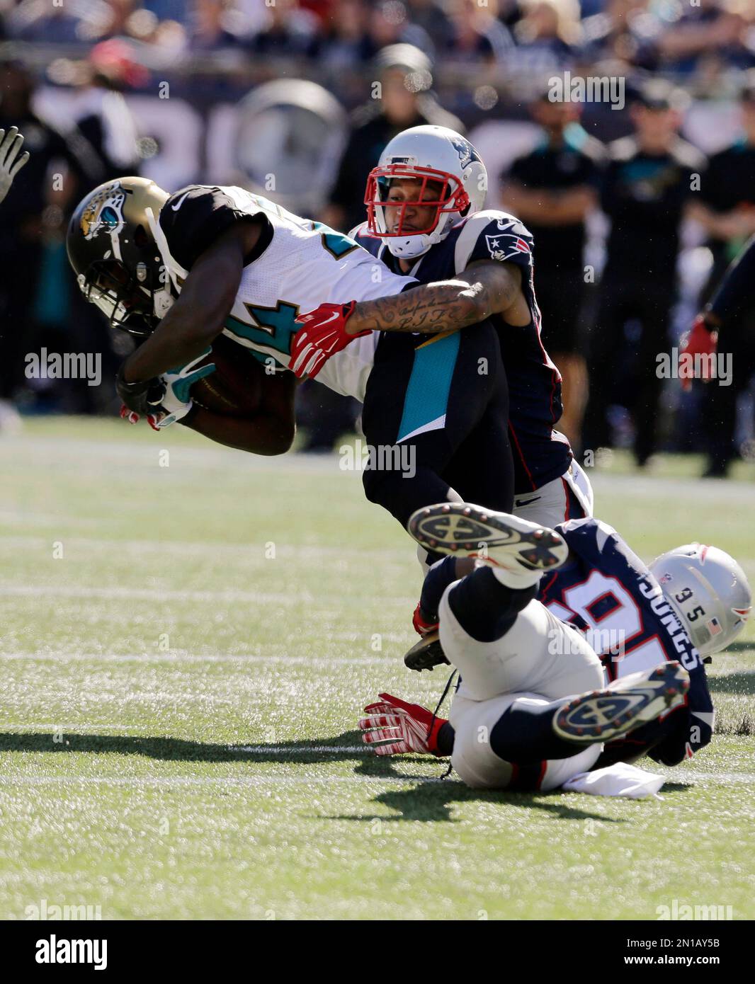 New England Patriots safety Patrick Chung, rear, and defensive end ...