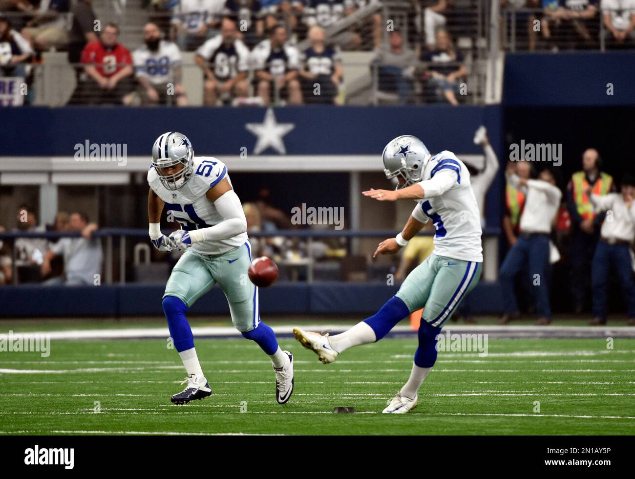 Dallas Cowboys punter Chris Jones punts the ball as outside linebacker ...